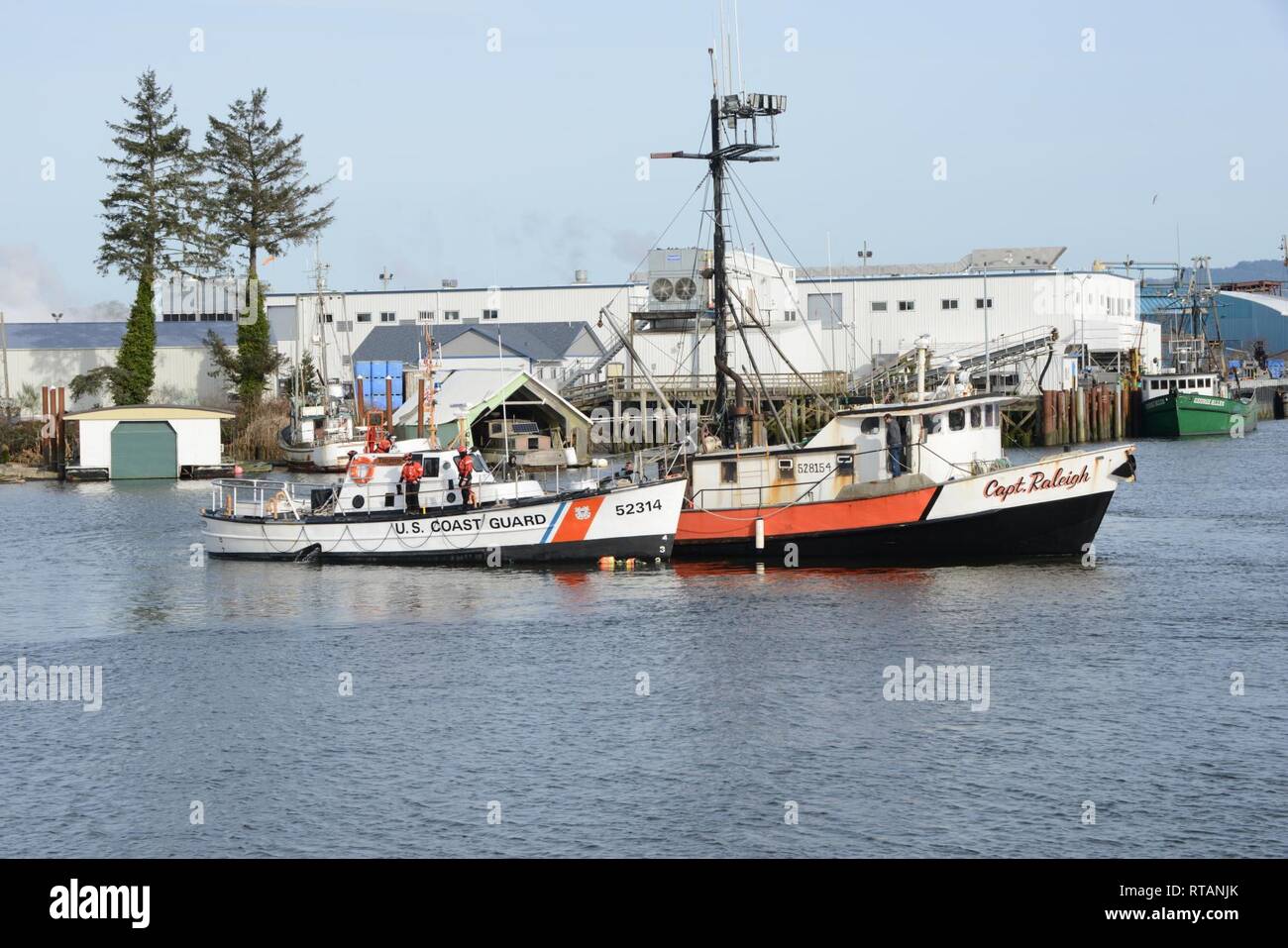 The commercial fishing vessel Capt. Raleigh is maneuvered toward a dock ...