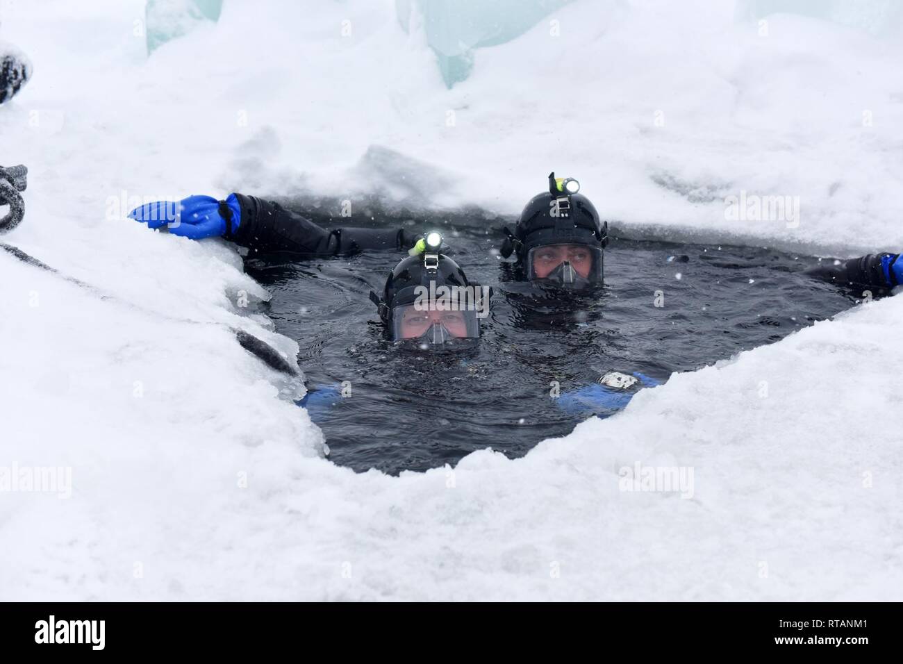 U.S. Navy divers from the Mobile Diving and Salvage Unit Two are ...