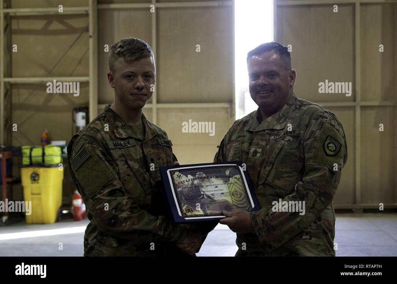 Spc. Nicholas Manley of the 3664th Maintenance Company receives a ...