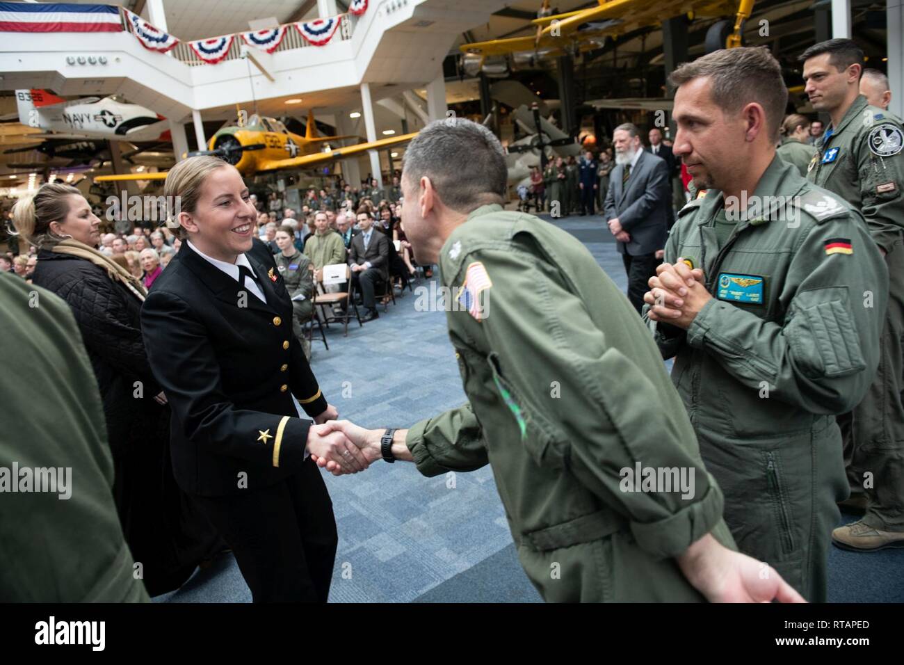 A Naval Flight Officer thanks instructors and staff during a Winging ...