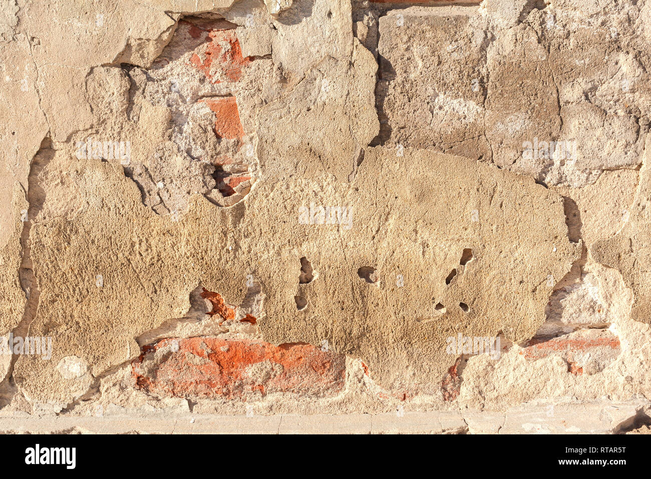 Stucco on a brick wall. Plaster falling off of an old brick wall. Old ...