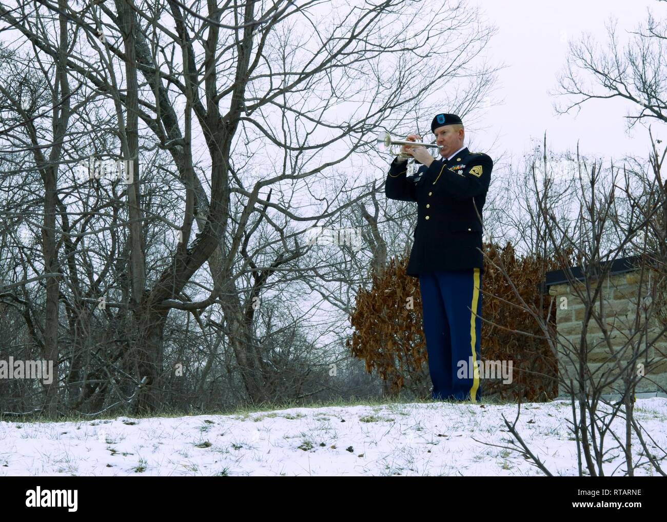 1st Sgt. Michael Eaton, 338th U.S. Army Band, plays Taps during a ...