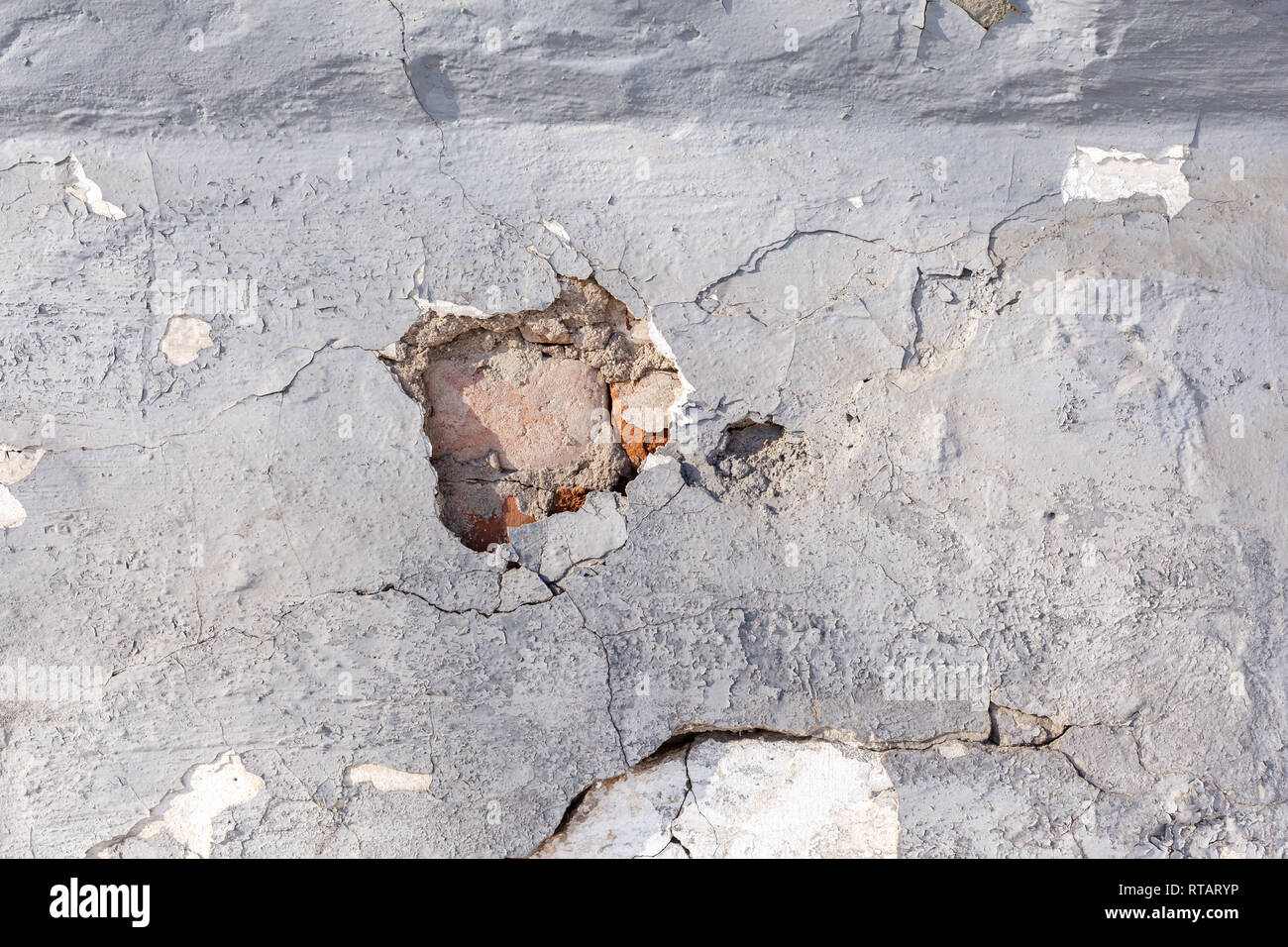 Stucco on a brick wall. Plaster falling off of an old brick wall. Old ...