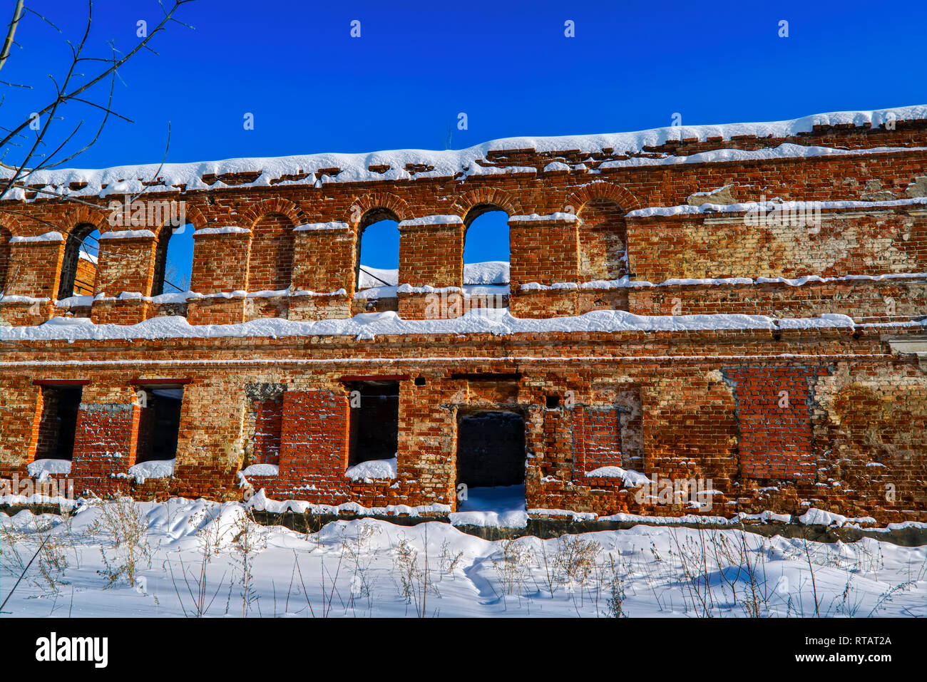 The ruins of an old brick building of red brick. The chimneys of the ...