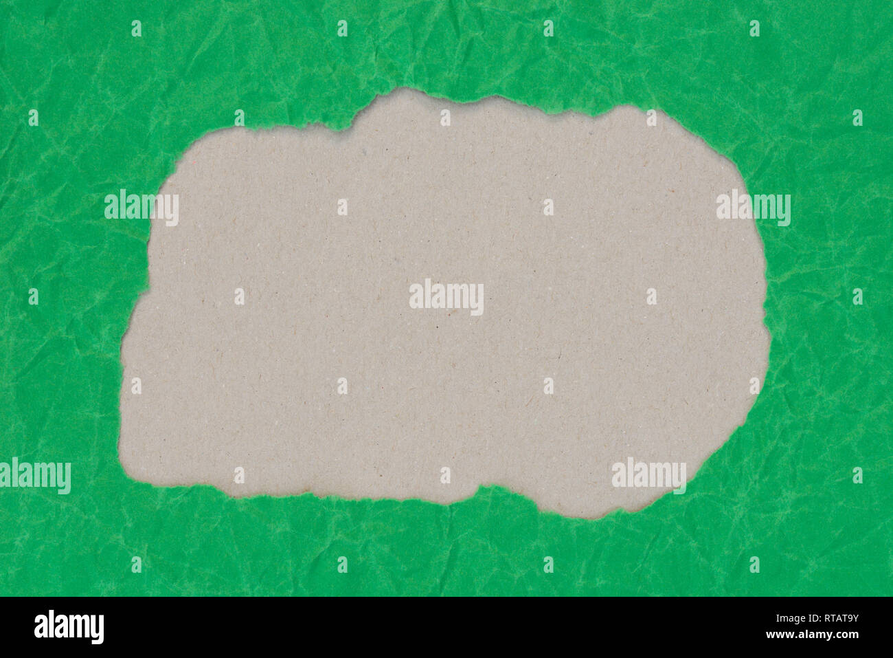 irregular shape hole on piece on green color paper Stock Photo - Alamy