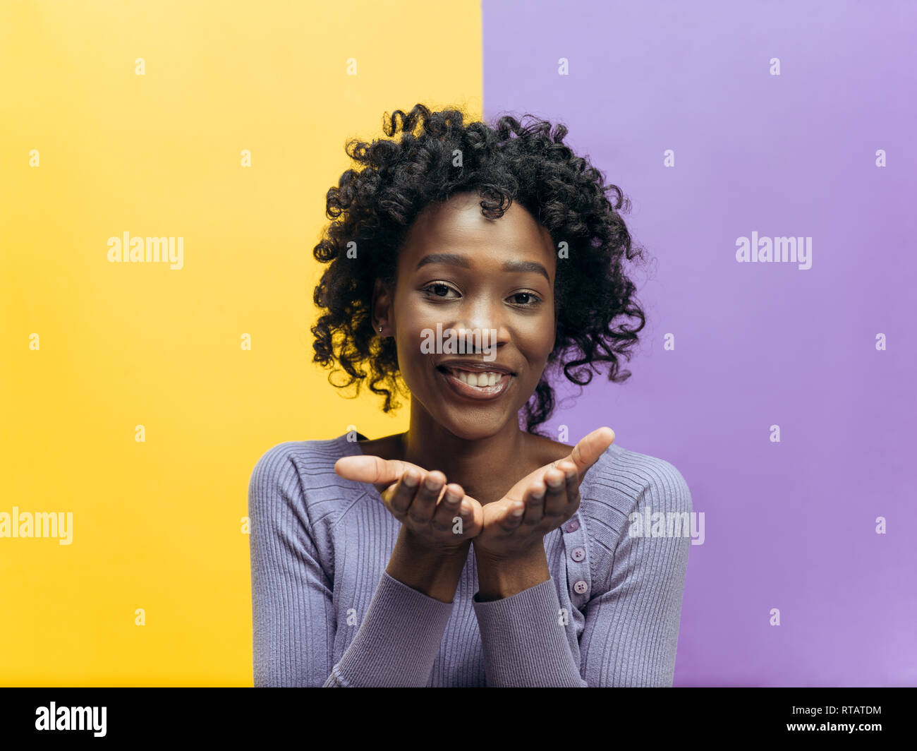 Happy woman standing and smiling isolated on color studio background ...