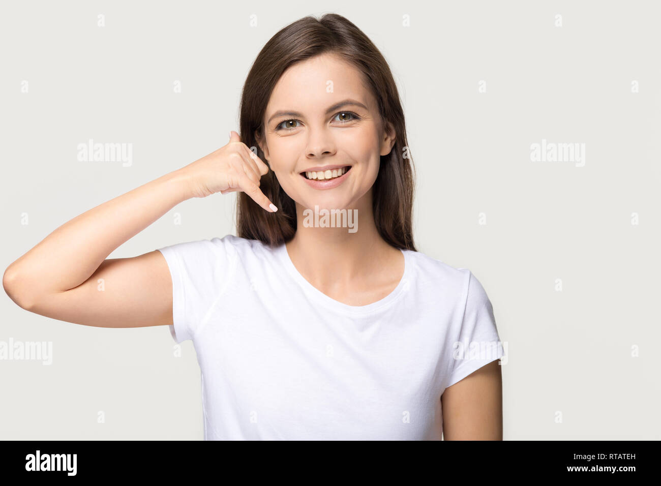 Happy girl showing call me phone gesture isolated on background Stock ...