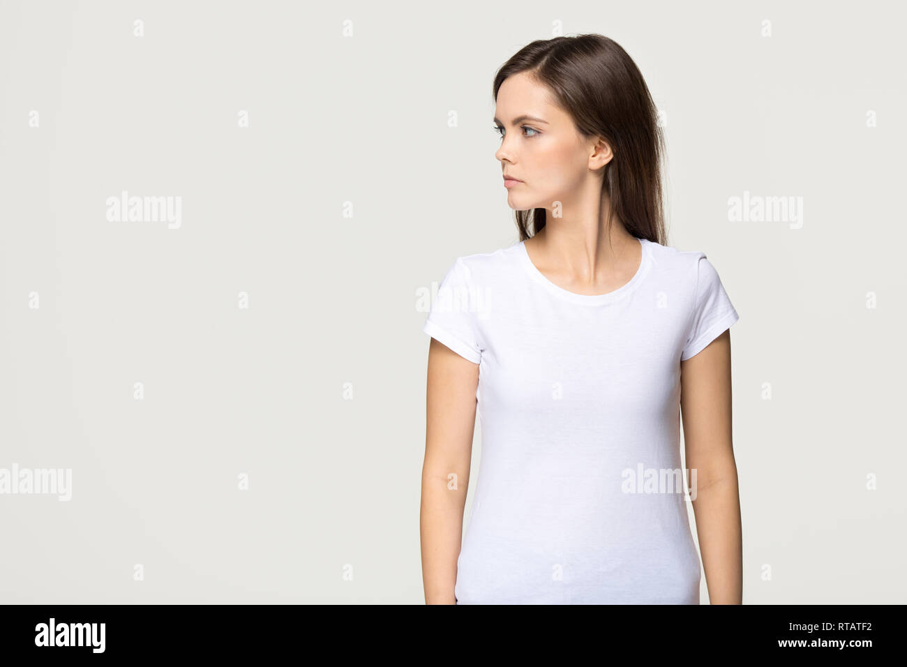 Confident young woman looking forward at copyspace isolated on ...