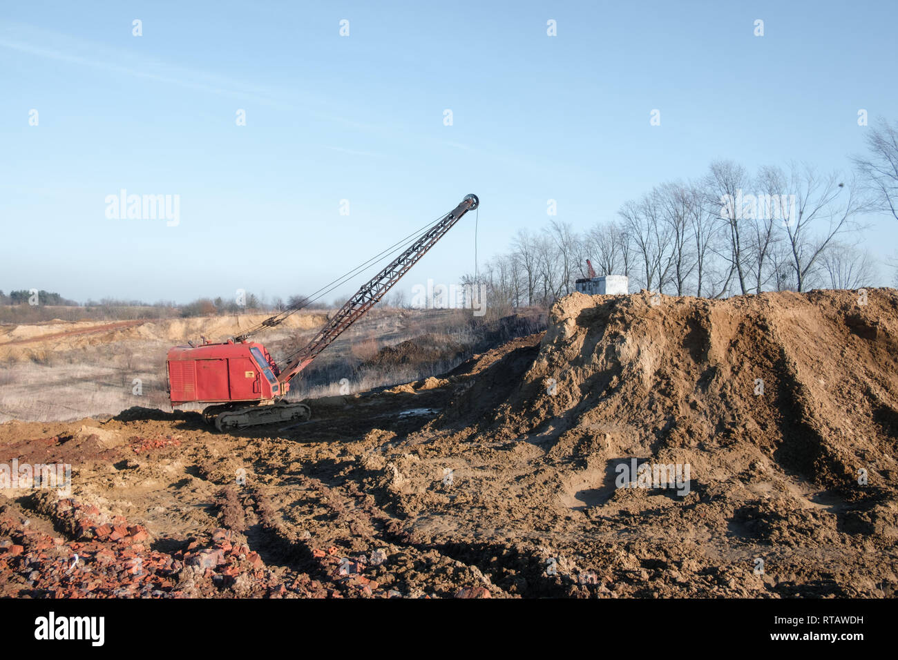 Excavator in the red clay quarry. Industrial background Stock Photo - Alamy