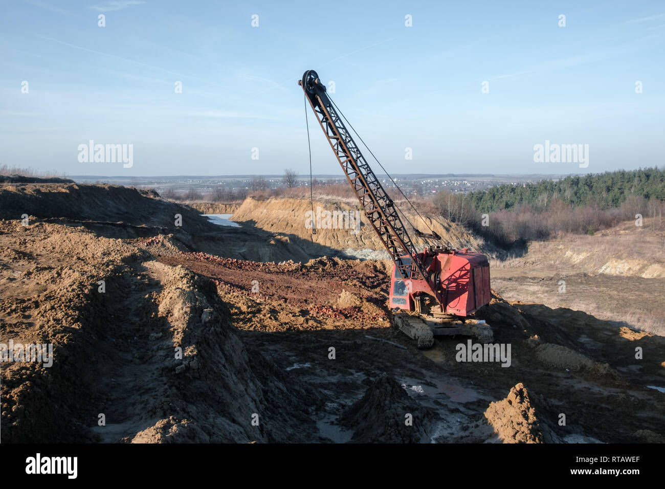 Excavator in the red clay quarry. Industrial background Stock Photo - Alamy