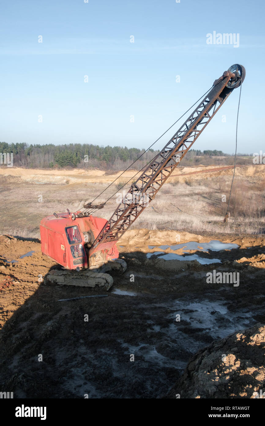 Excavator in the red clay quarry. Industrial background Stock Photo - Alamy