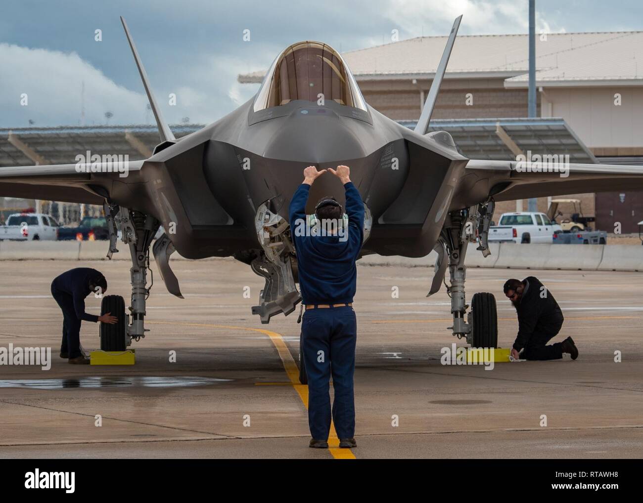 A Lockheed Martin crew chief signals to the F-35A Lightning II pilot ...