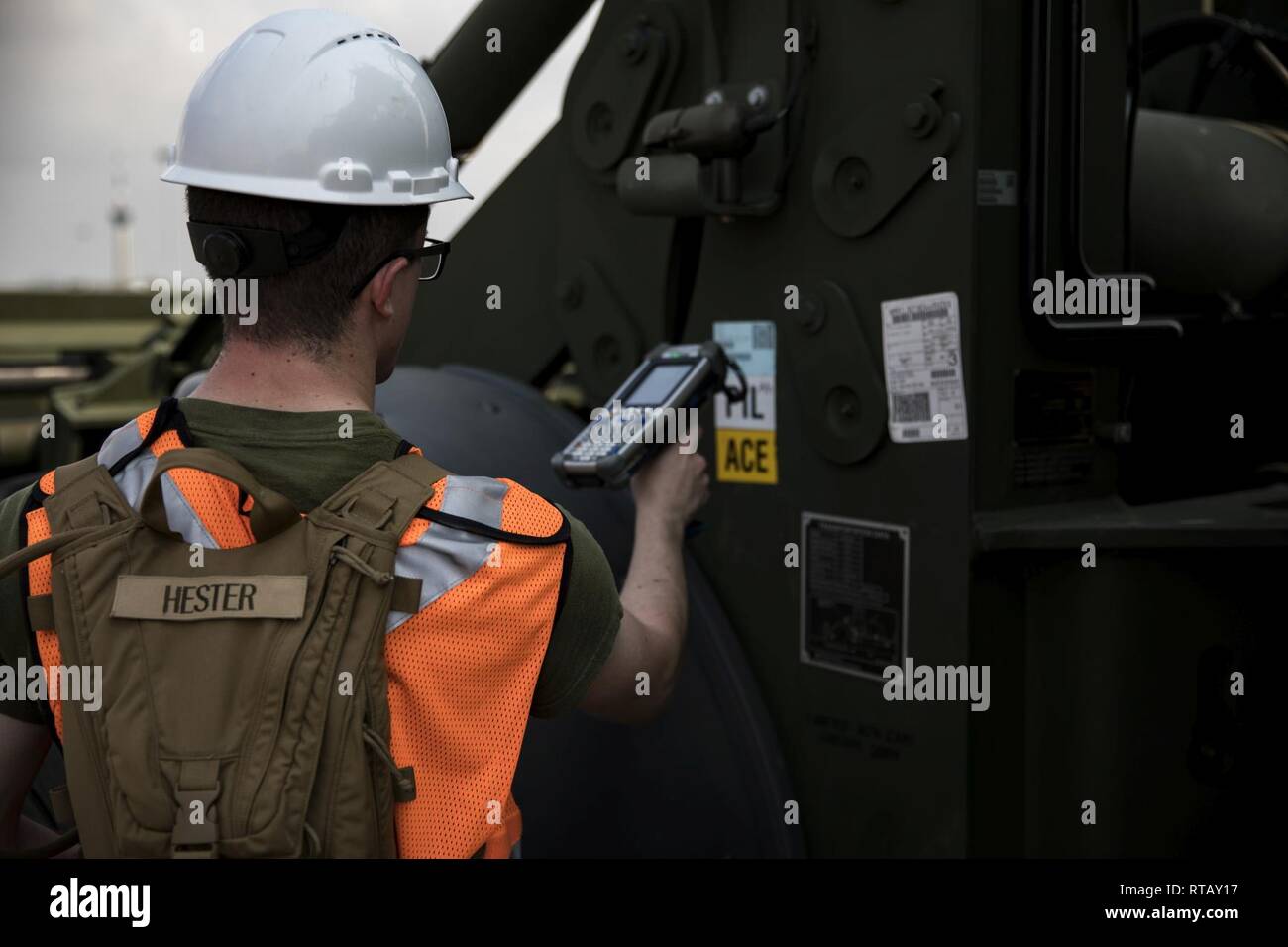 Lance Cpl. Zakary Hester scans the barcode on a front-end loader during ...