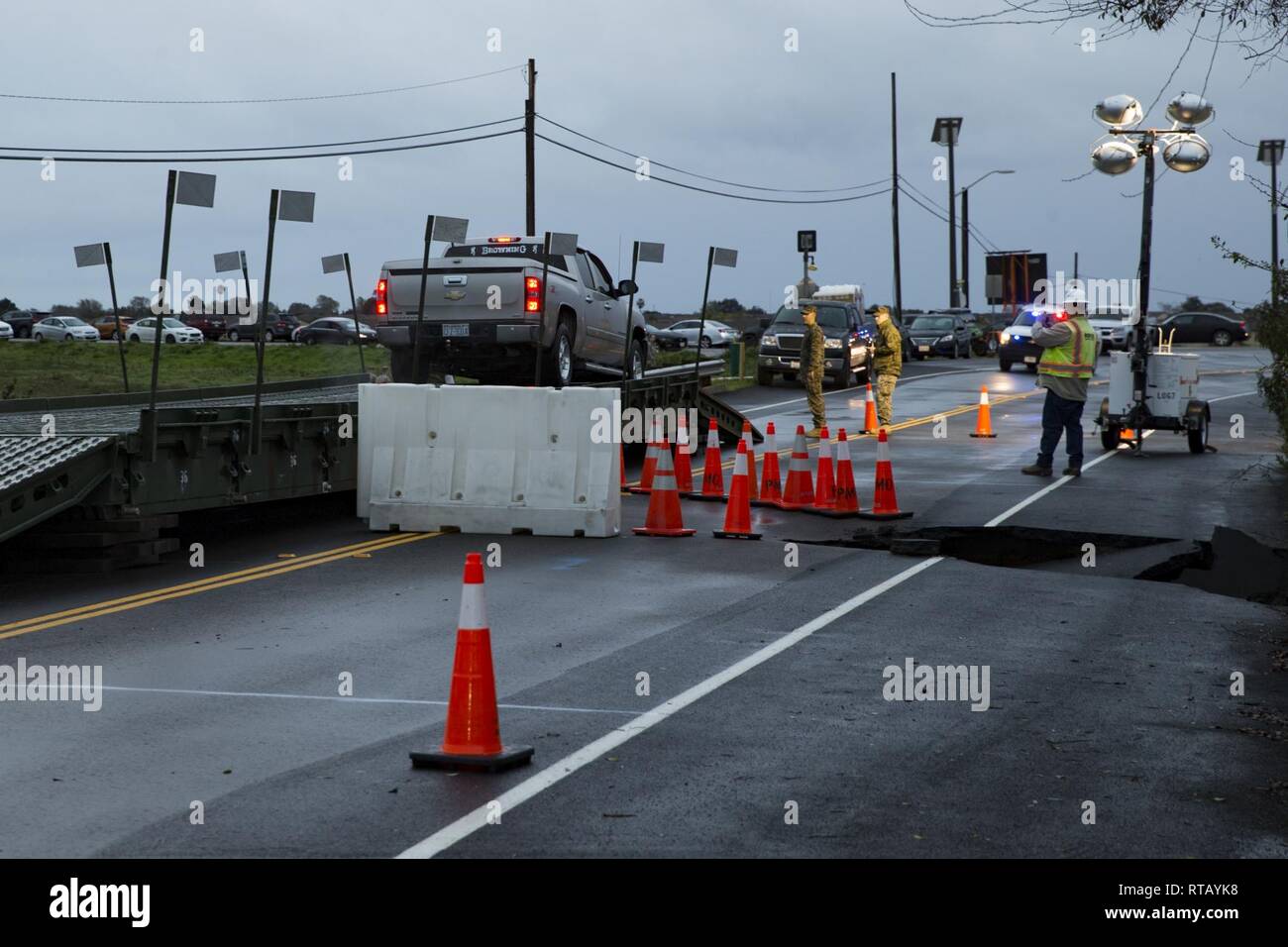 An emergency vehicle crosses a medium girder bridge on Carnes Road at ...