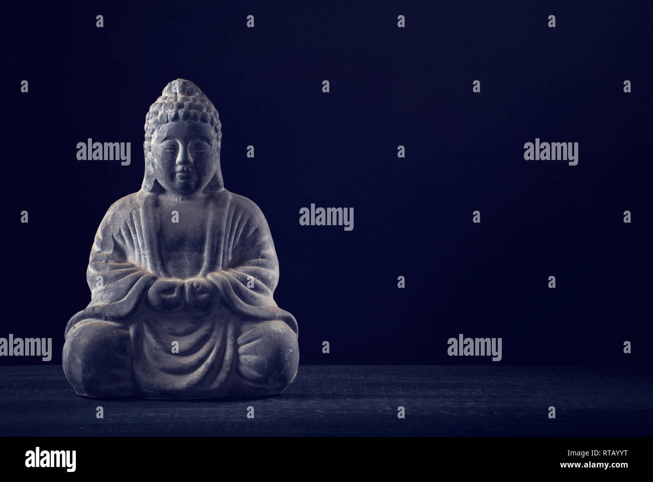 Buddha statue on a black background Stock Photo - Alamy