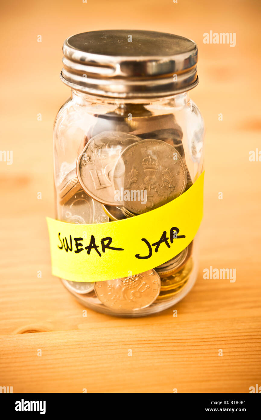 swear jar with coins inside Stock Photo - Alamy
