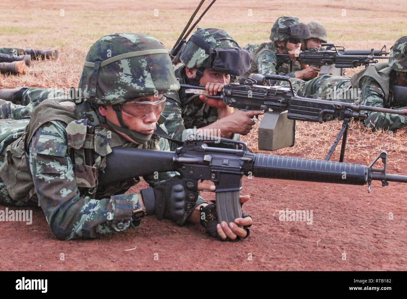 Soldiers with the Royal Thai Army pull security while waiting for Sikorsky UH-60 Black Hawks ...
