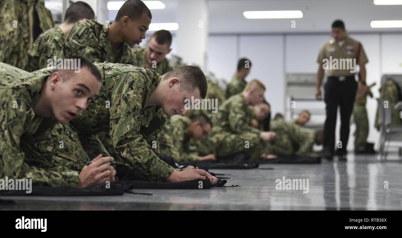 GREAT LAKES, Ill. (Feb. 6, 2019) Recruits stencil their uniforms inside ...