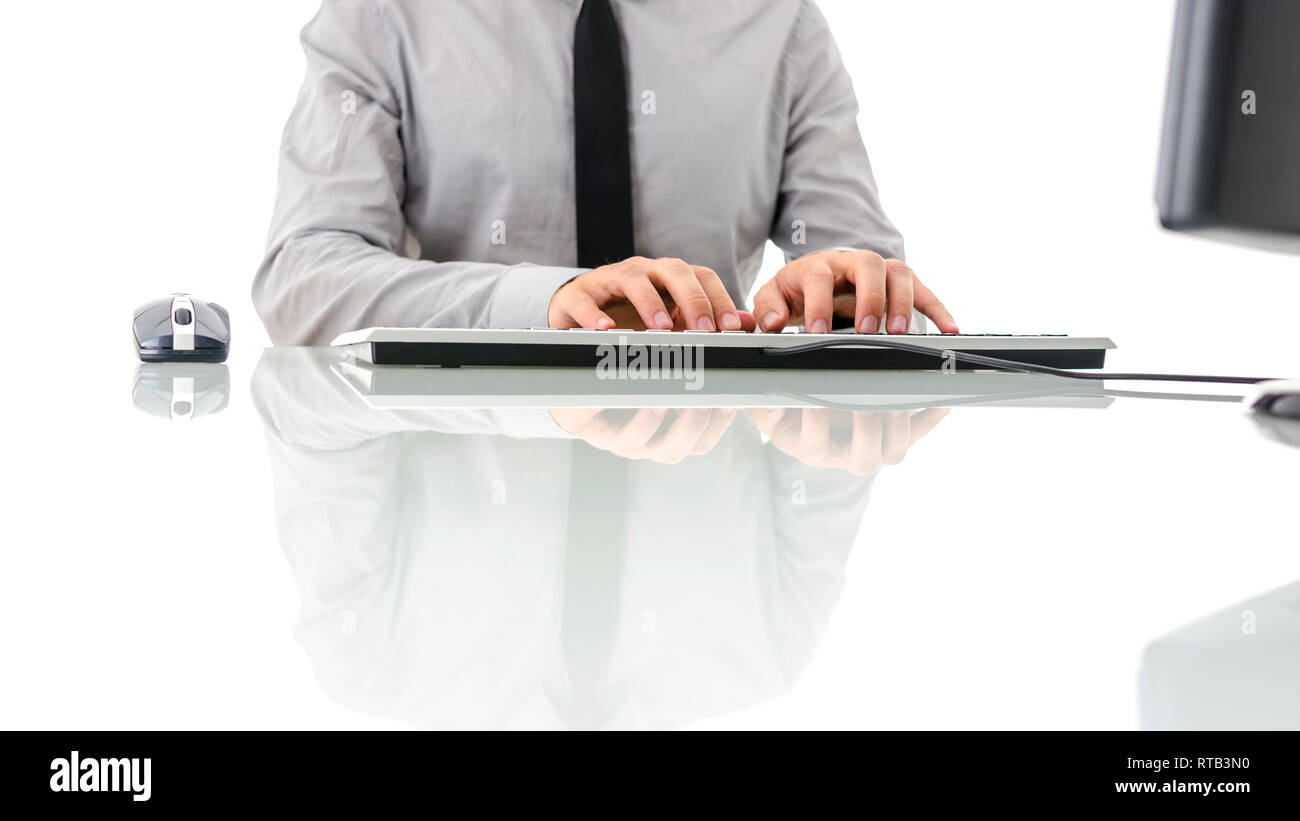 Front view of businessman working on computer on his white office desk ...