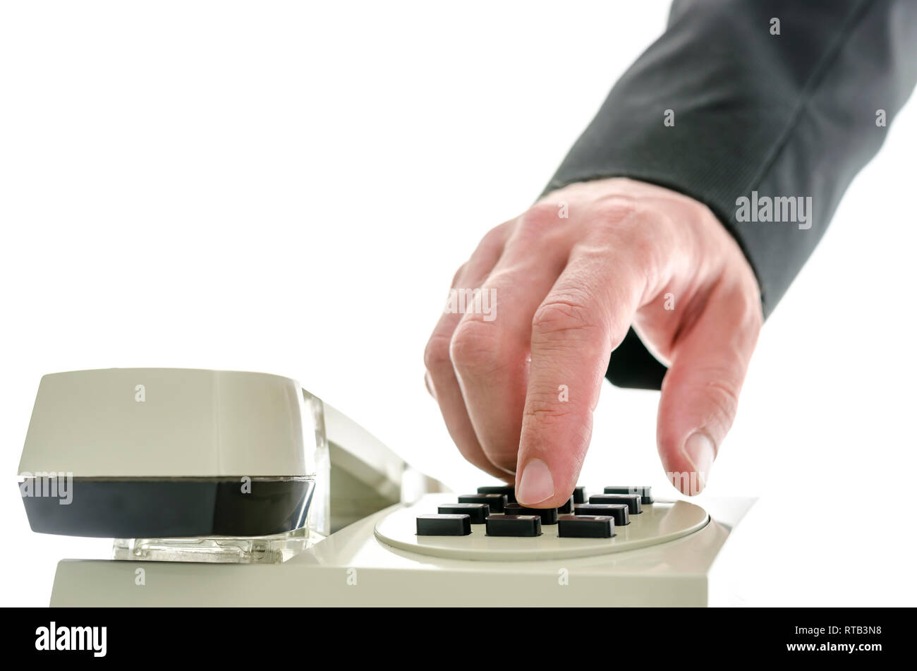 Front view of business man hand dialing a telephone number on an old ...