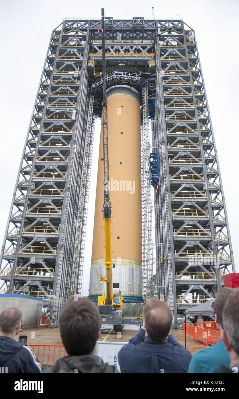 Members of a NASA-led tour group look up at the 215-foot-tall ...