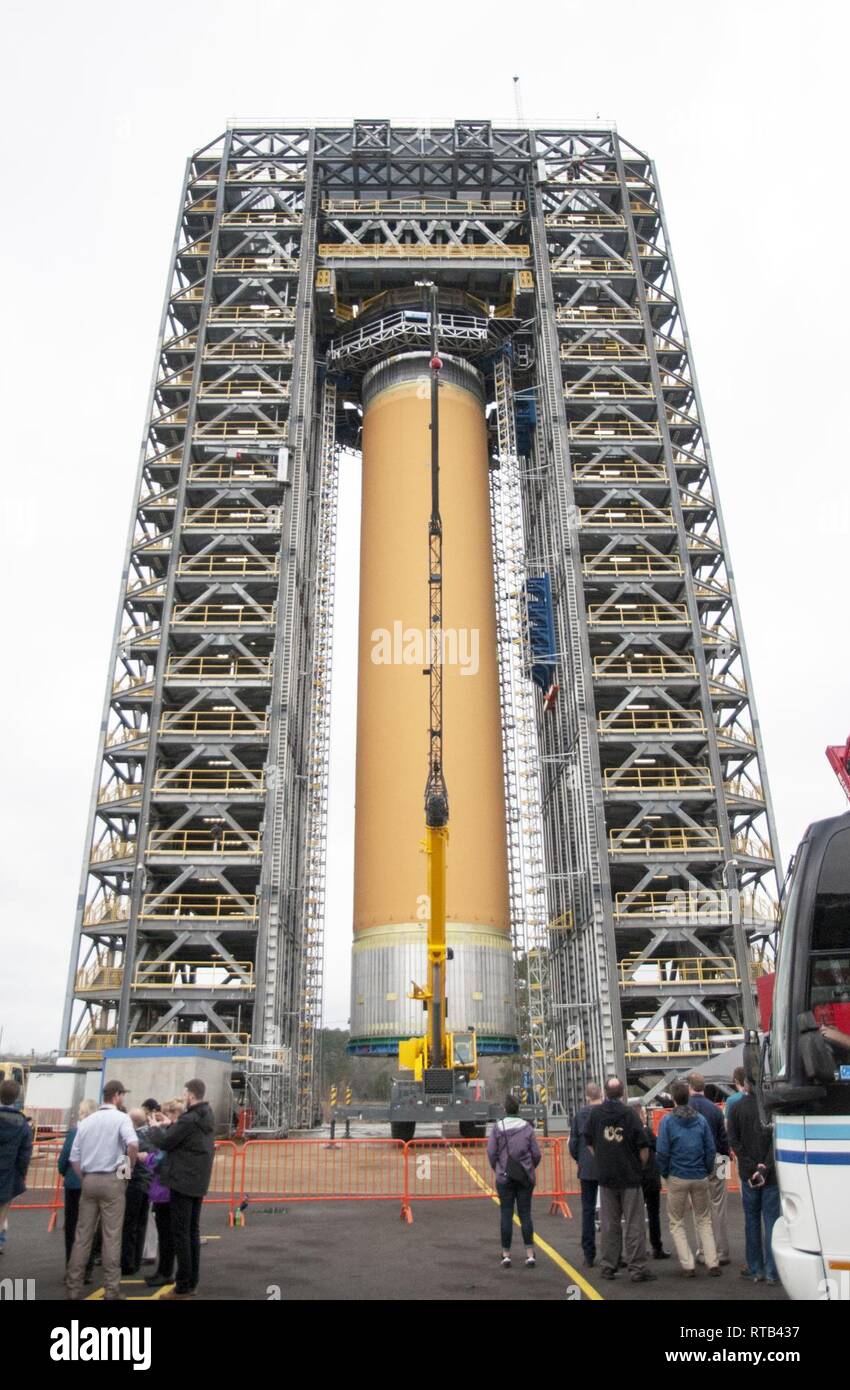 Members of a NASA-led tour group look up at the 215-foot-tall ...