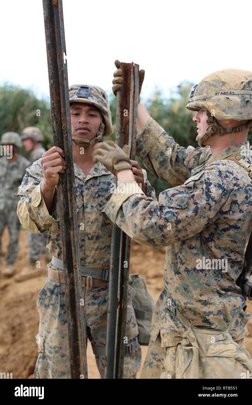 Sgt. Thiavadem Thang, left, and Lance Cpl. Bryce Taft separate stakes ...