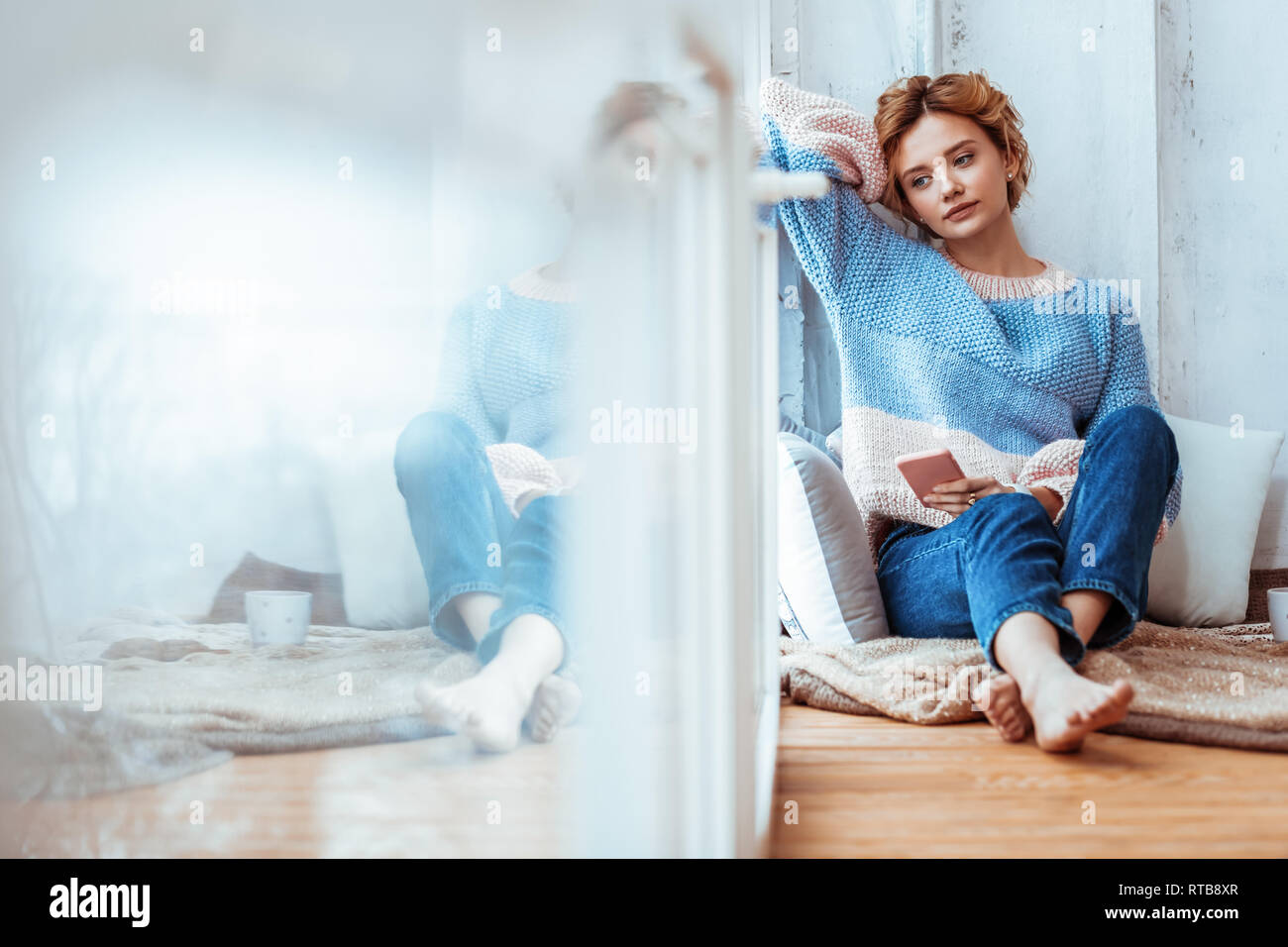Sad young woman waiting for a message Stock Photo - Alamy