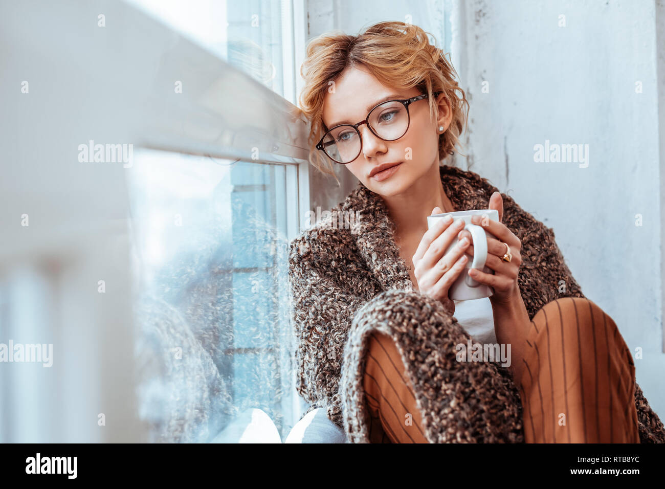 Sad cheerless woman being covered with plaid Stock Photo - Alamy
