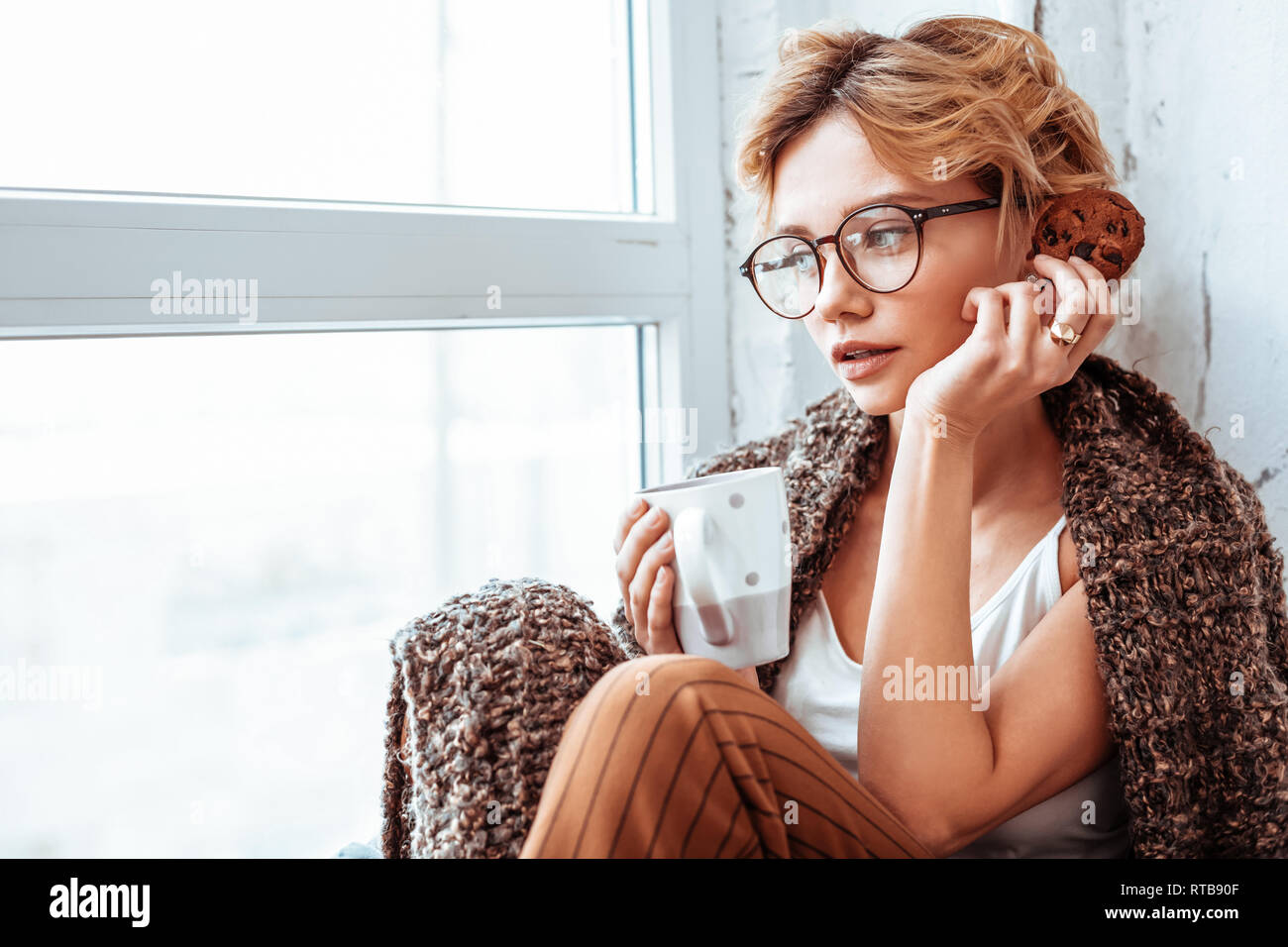 Sad thoughtful woman sitting with a cup of tea Stock Photo - Alamy