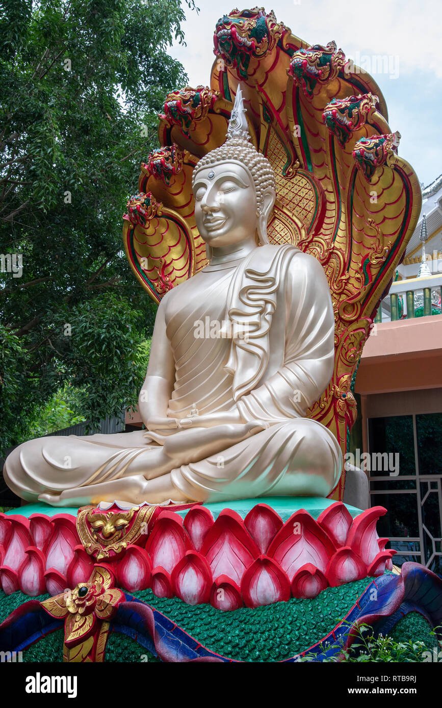 White Buddha statue with the seven head serpent sculpture which located ...