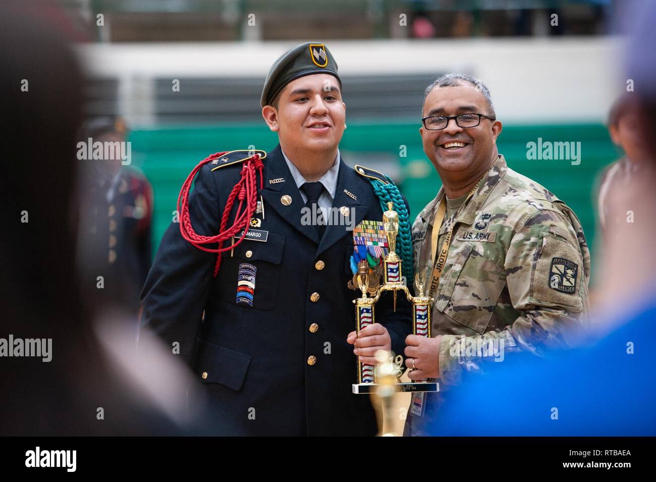 A Junior Reserve Officer Training Corps cadet poses with a trophy ...