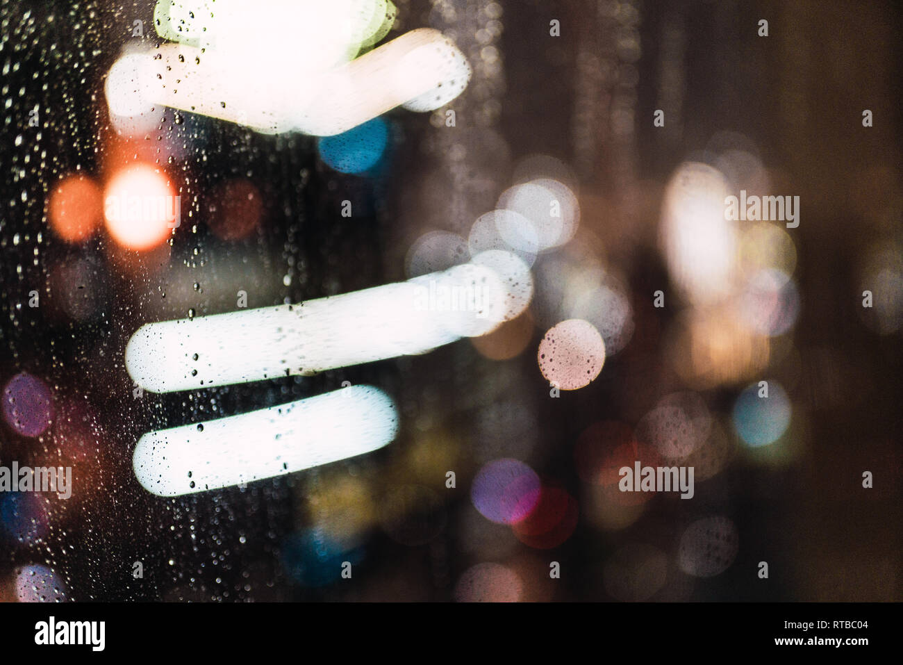 Night city through wet glass Stock Photo - Alamy