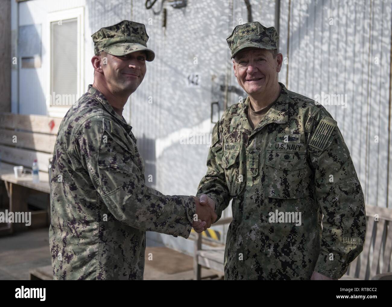 Chief of Navy Reserve Vice Adm. Luke McCollum presents a coin to U.S ...