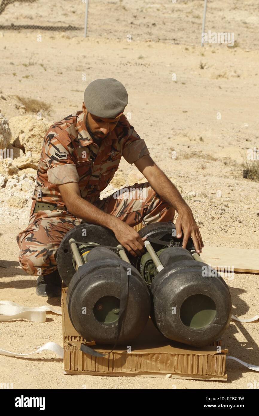 A soldier from the Sultan of Oman's Parachute Regiment examines the ...