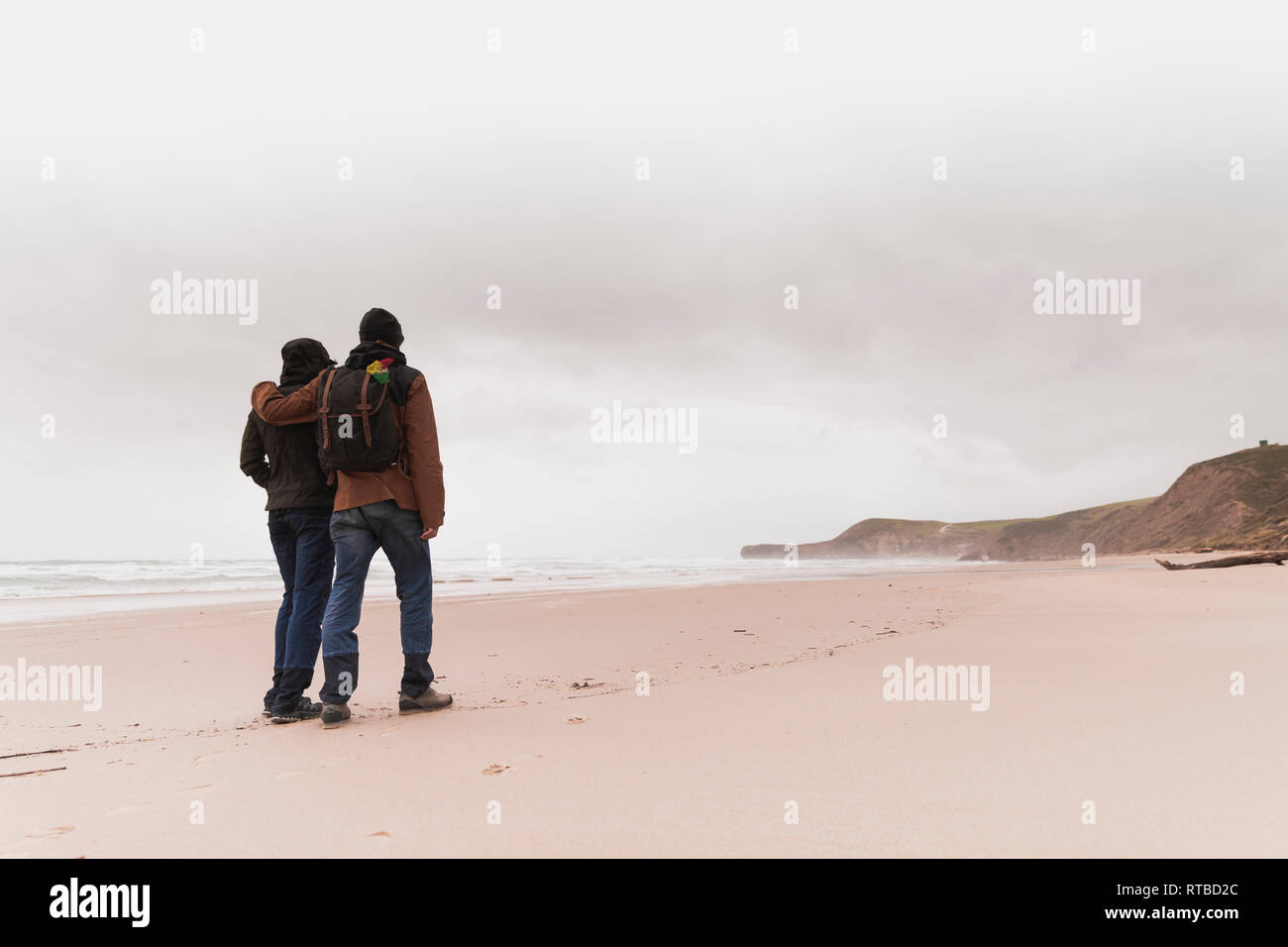 Crop anonymous female illustrator in dirty robe and gloves sitting on ...