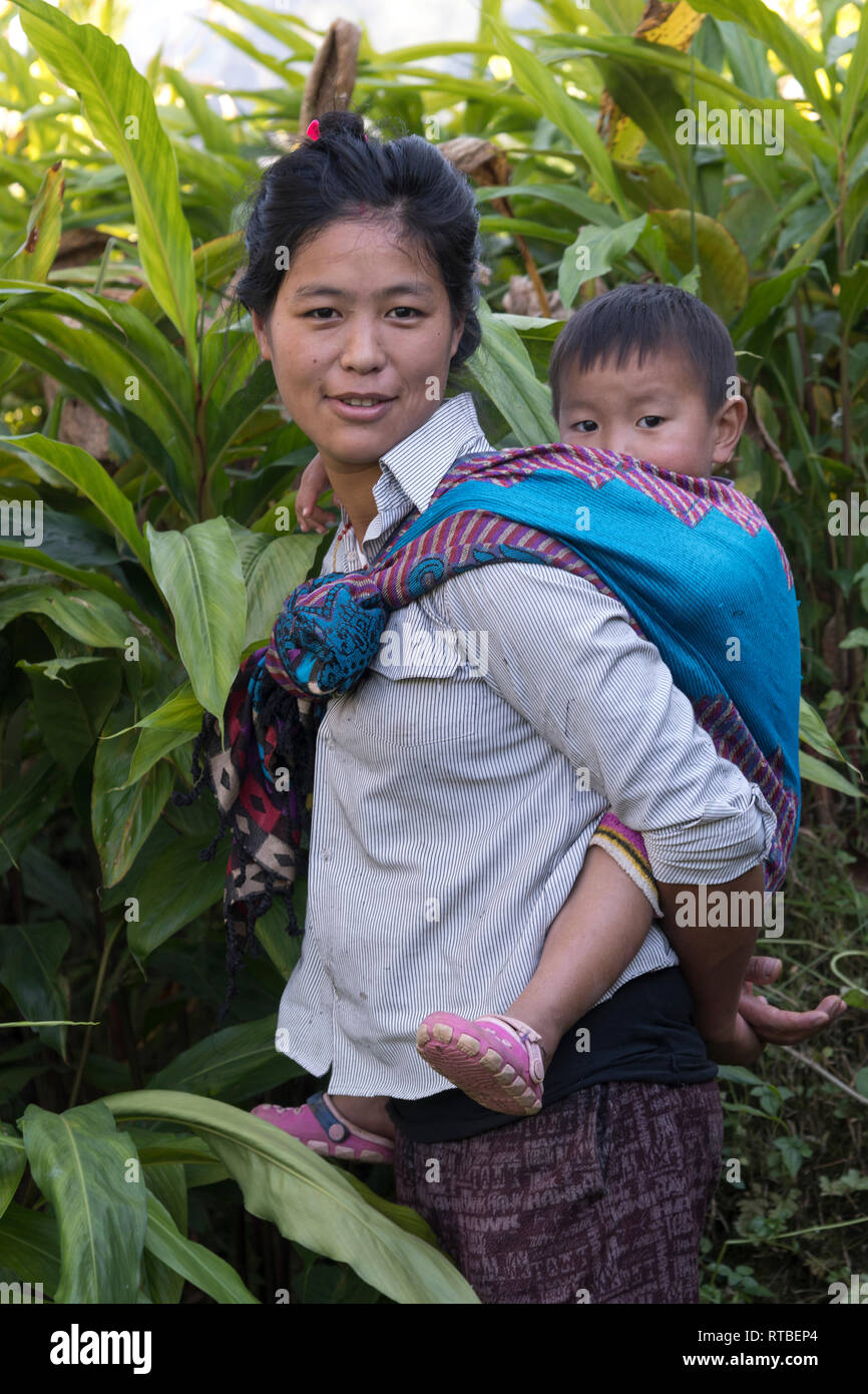 Woman carrying her baby in field, Yangthang Village, Gyalshing, West ...
