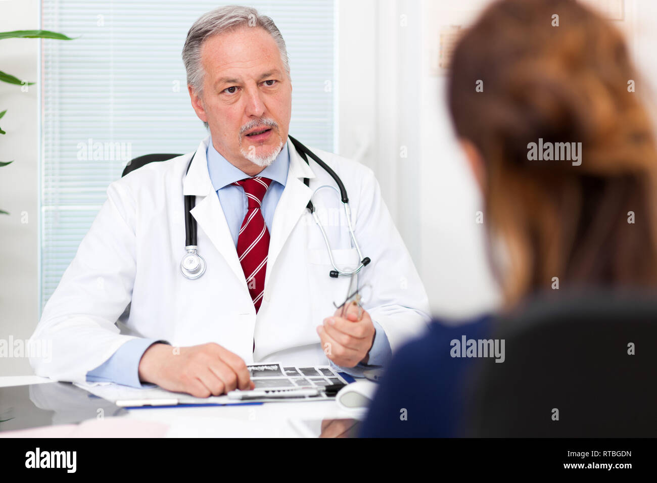 Doctor talking to his patient Stock Photo - Alamy