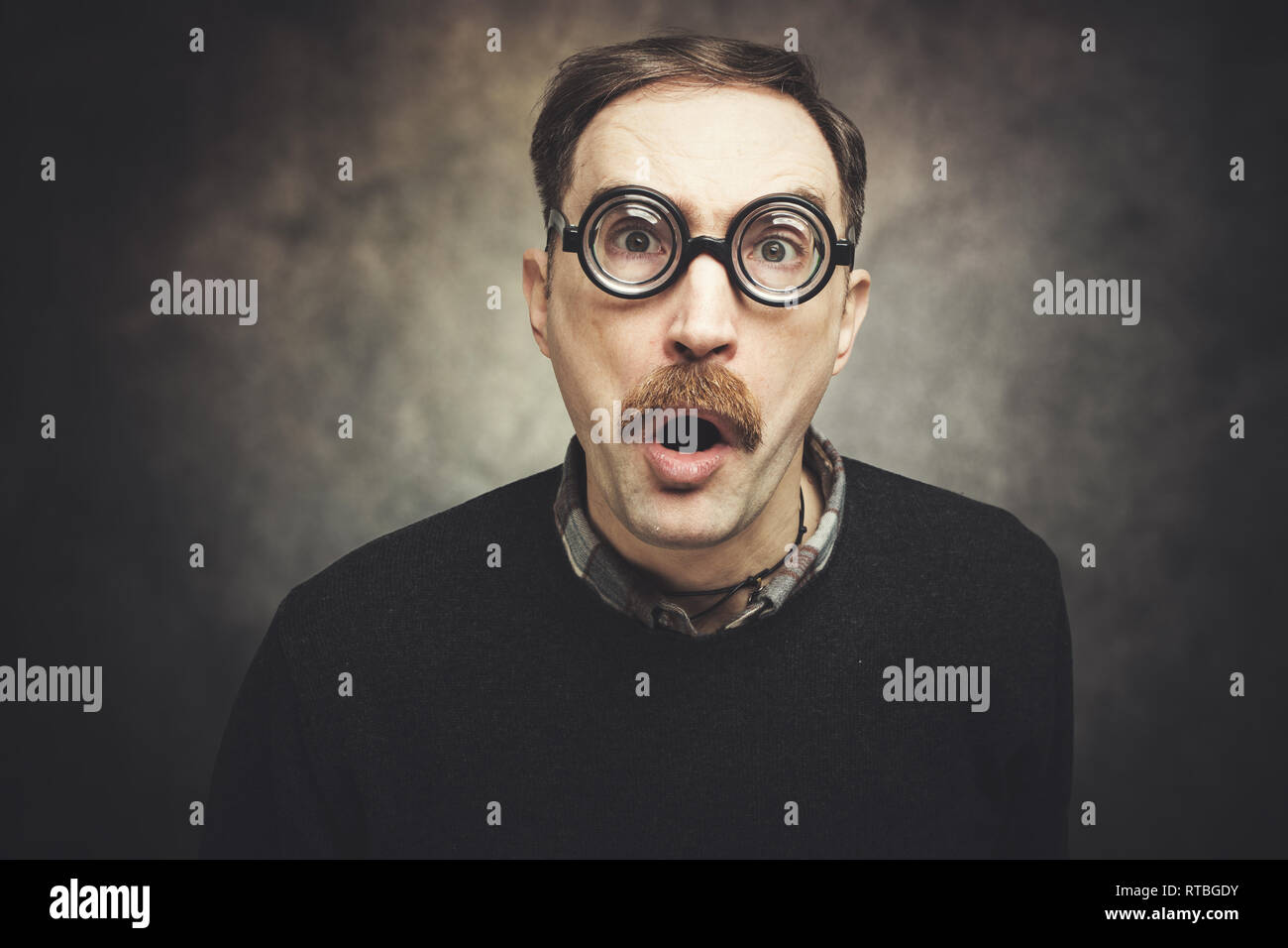 Funny portrait of a ner mand wearing nerd glasses Stock Photo - Alamy