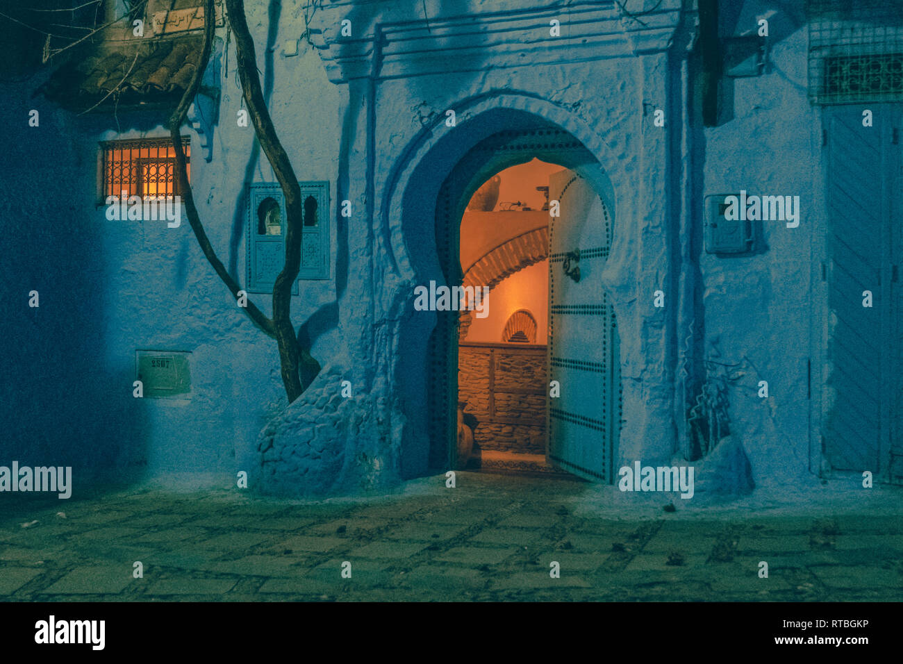 Facade of old stone building with white walls and vintage doors in ...