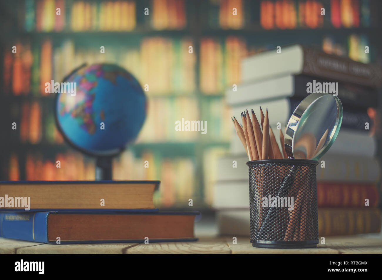 Textbooks, globe and pencils on a wooden background. Educational ...