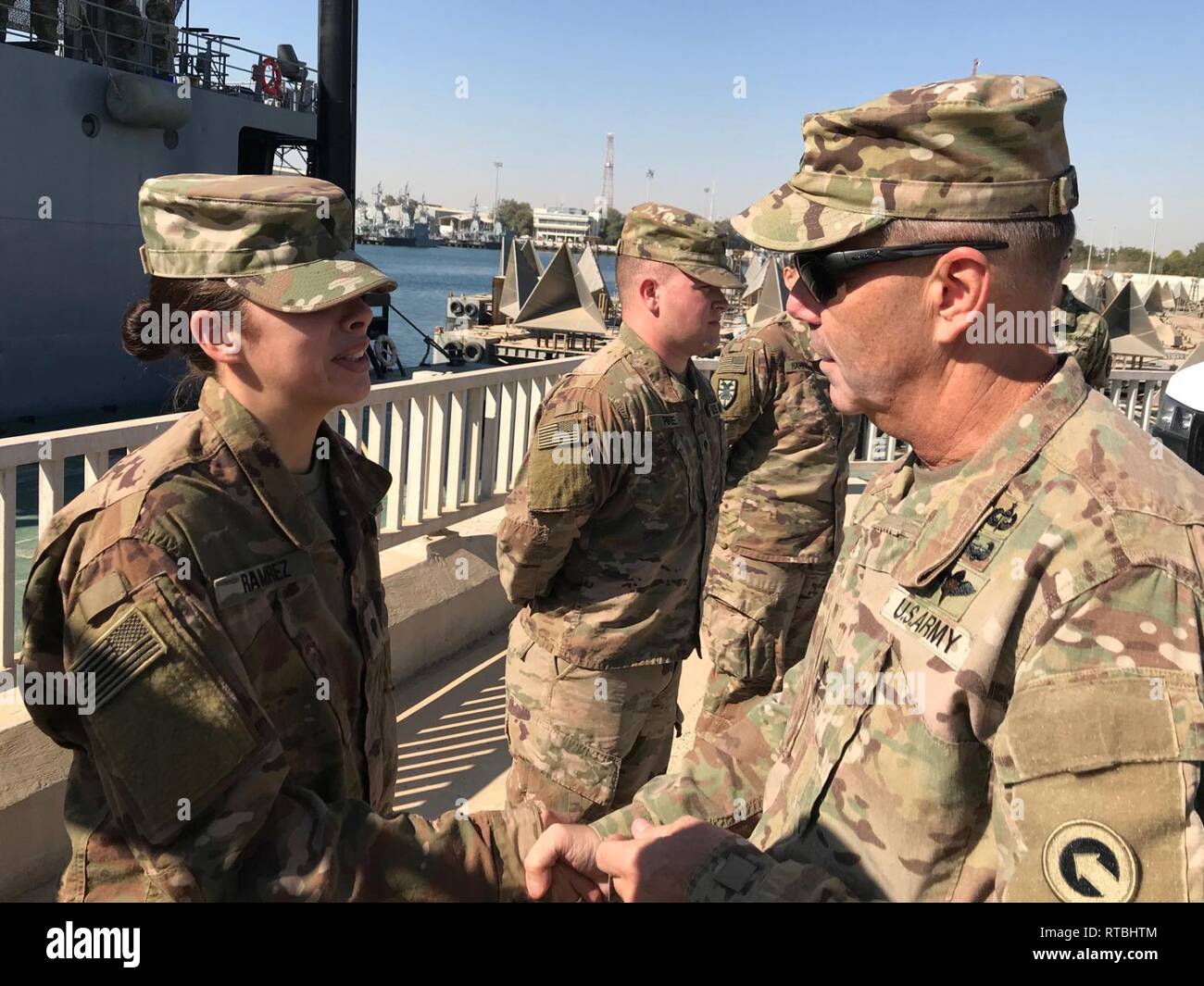 Spc. Selena Ramirez, 393d Transportation Detachment, receives a coin ...