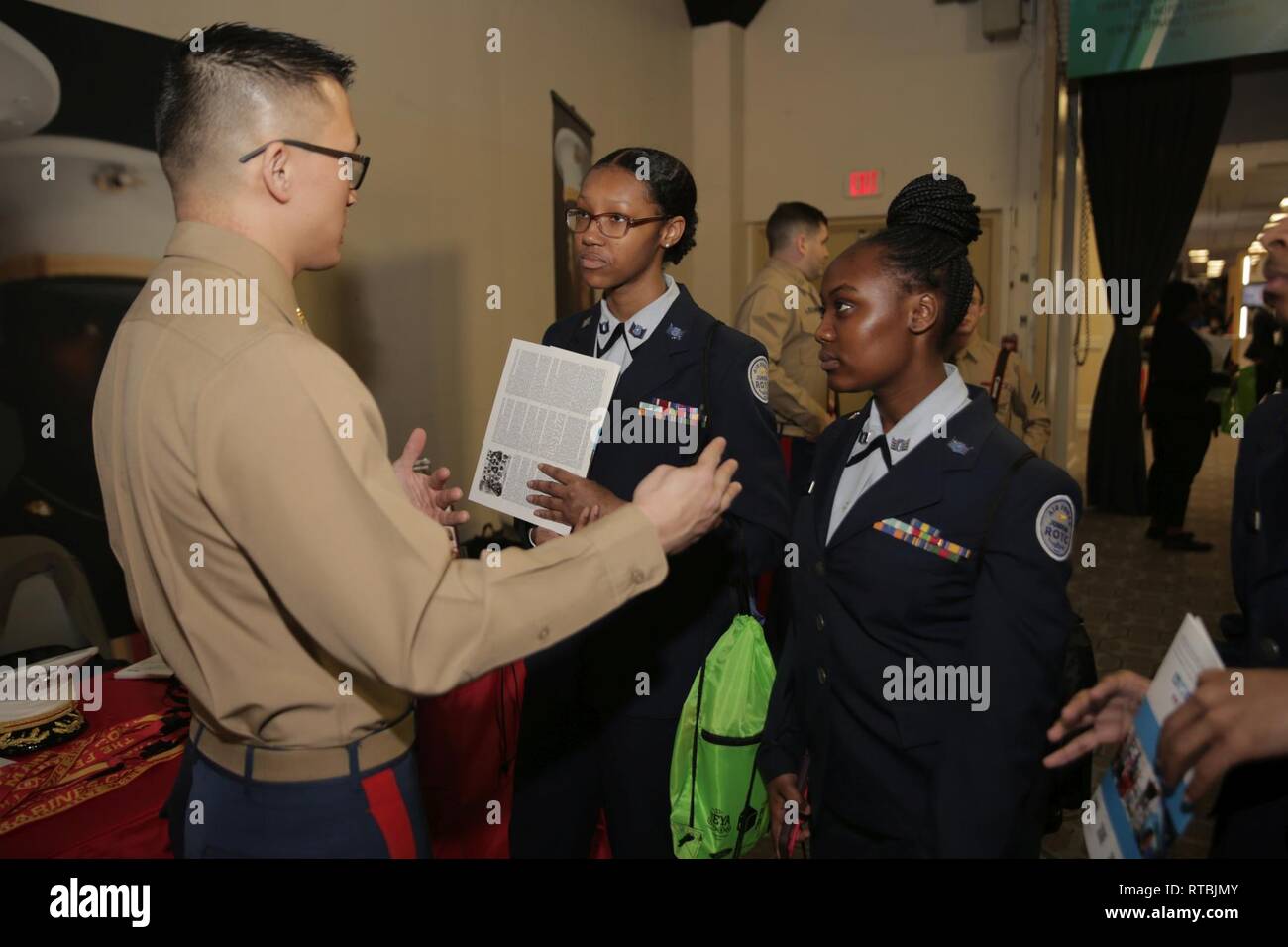 WASHINGTON — Maj. David Hankle speaks to Nia Levy (left) and Opeyeni ...