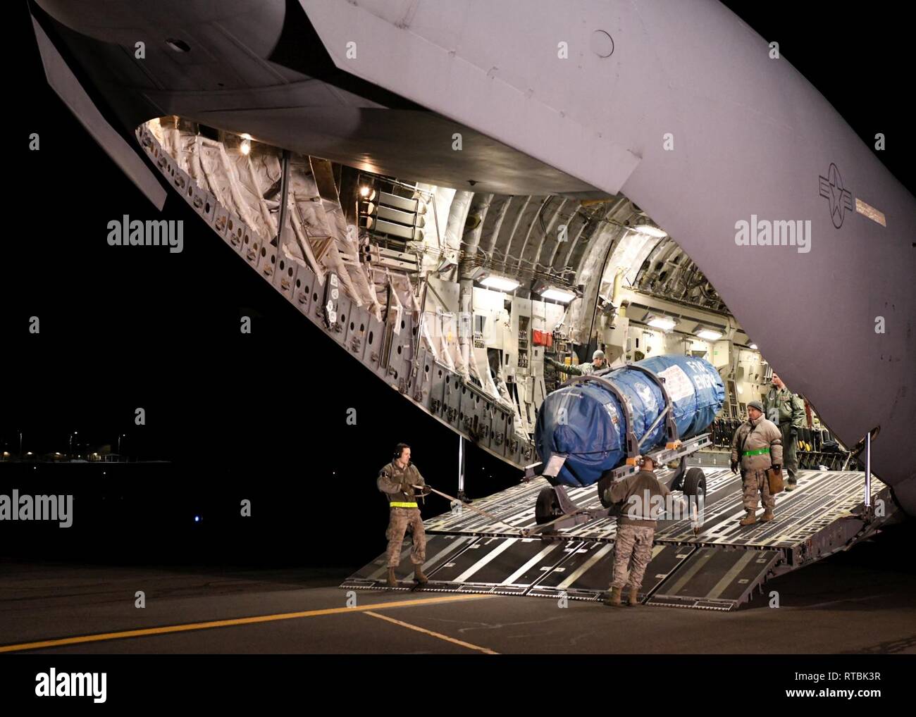 Airmen from the 104th Logistics Readiness Squadron work with the crew ...