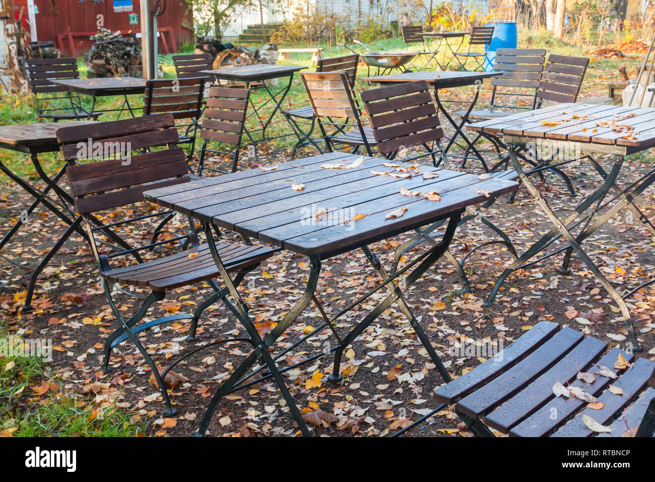 Beautiful autumn in old outdoor cafe in the park - wet tables and ...