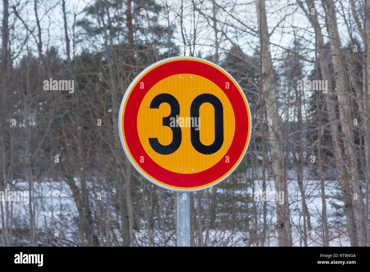 Speed limit 30 kilometers per hour road sign on trees background at ...