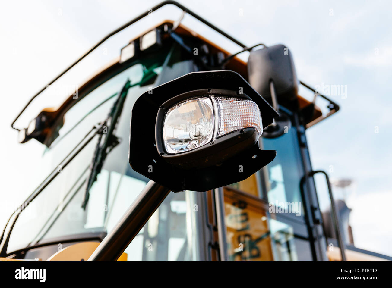 Headlight on the front of a powerful tractor excavator industrial ...