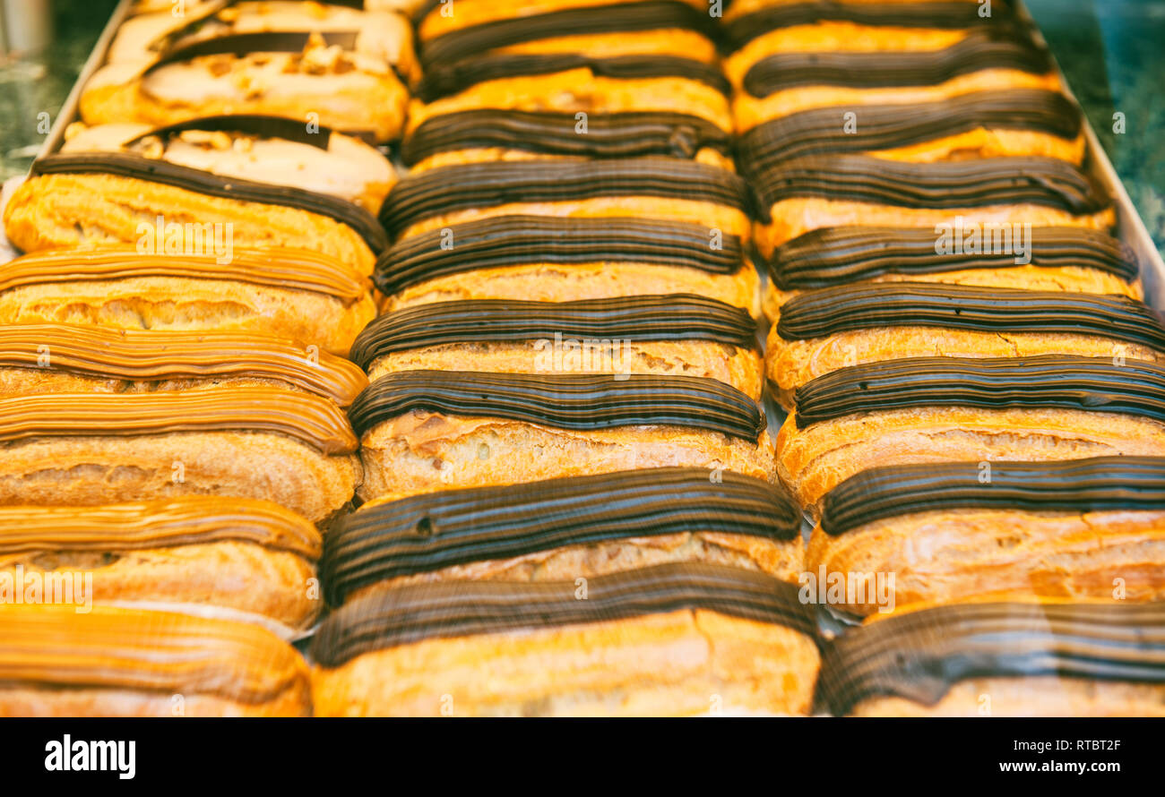 Traditional french eclairs sweets in French bakery store window ...