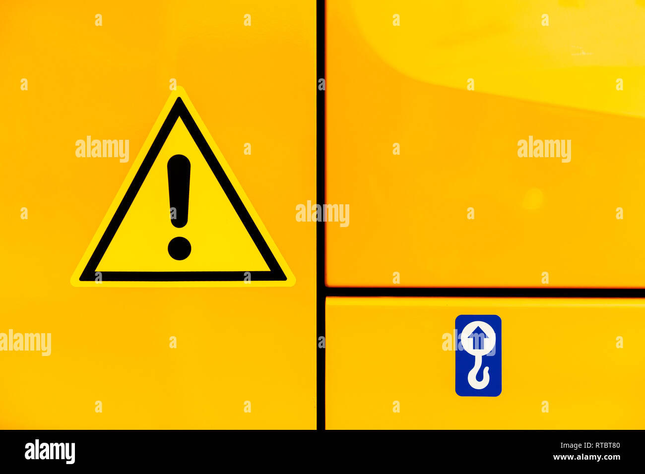 Attention yellow triangle sign on the yellow industrial construction ...