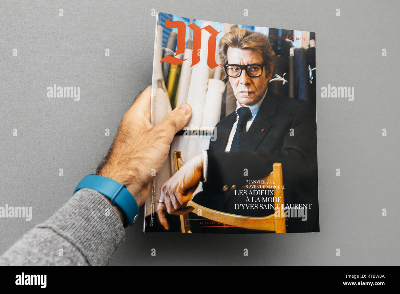 PARIS, FRANCE - OCT 4, 2017: Man holding M Magazine le monde with Yves ...